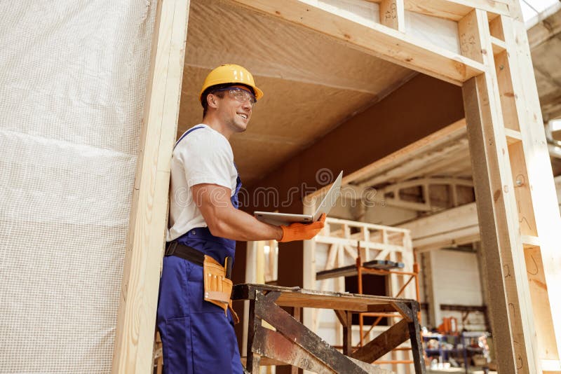 Joyful Male Builder Using Laptop at Construction Site Stock Image ...