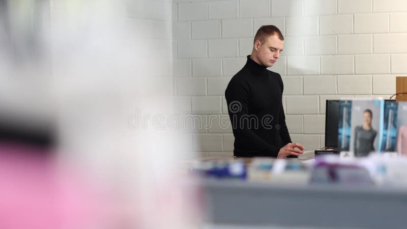 Handsome Man Worker Stands at the Checkout Using Computer. Close-up ...