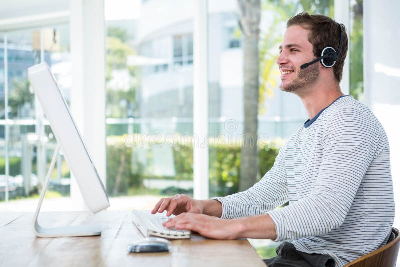 Handsome Man Working on Computer with Headset Stock Image - Image of ...