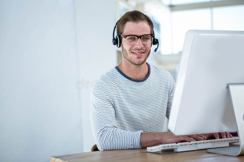 Handsome Man Working on Computer with Headset Stock Image - Image of ...
