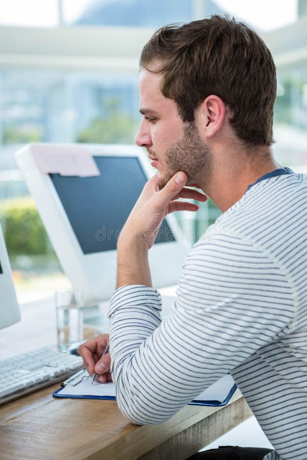 Handsome Man Working on Computer and Taking Notes Stock Image - Image ...