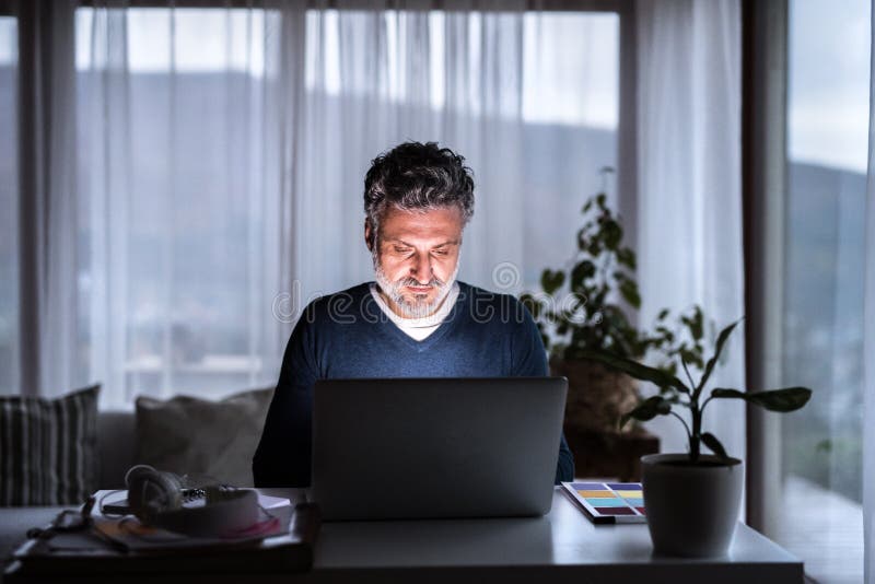 Handsome Man Working from Home Office at Evening, Using Laptop. Screen ...