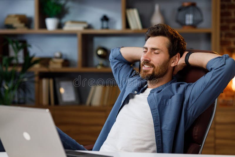 Handsome Man Working on Laptop while Sitting at Home Office. Relax ...