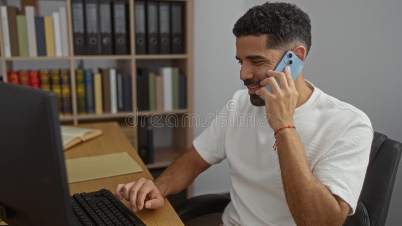 Handsome Man Working in Office Talking on Phone Smiling while Typing ...