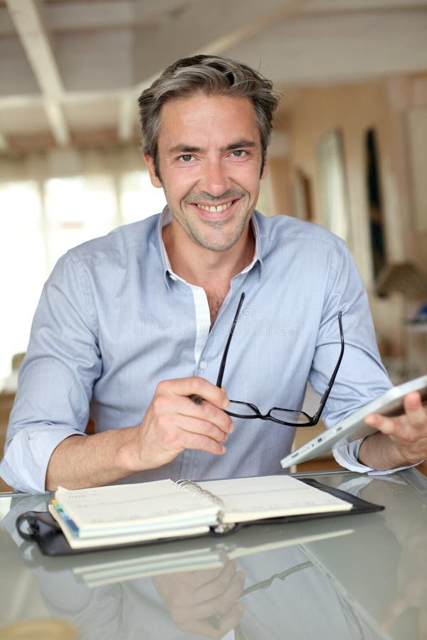 Handsome Man Working on Tablet at Home Stock Photo - Image of adult ...