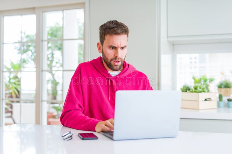 Handsome Man Working Using Computer Laptop Afraid and Shocked with ...