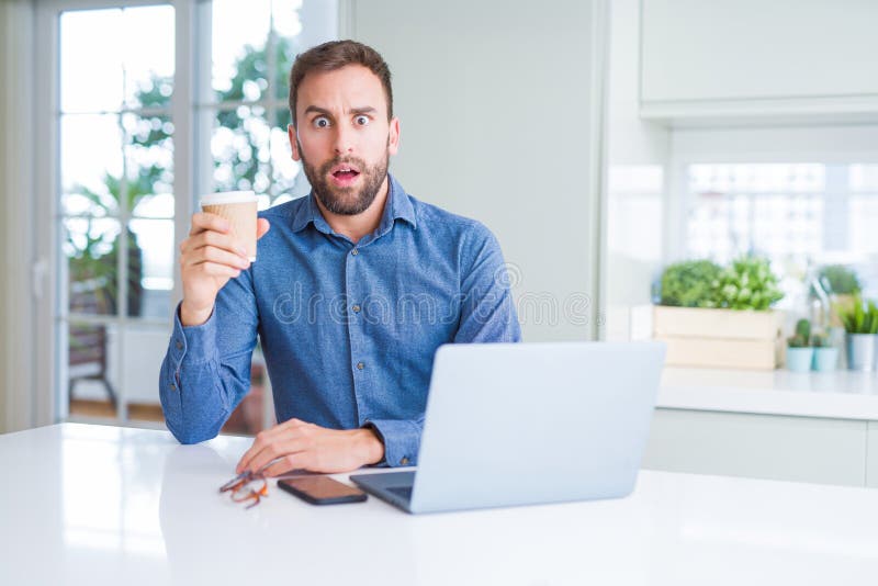 Handsome Man Working Using Computer Laptop and Drinking a Cup of Coffee ...