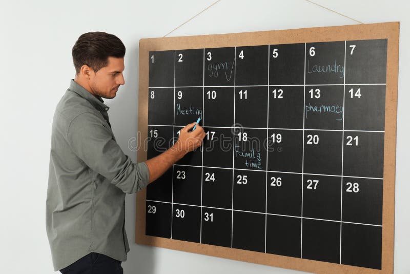 Handsome Man Writing with Chalk on Calendar Stock Image - Image of ...