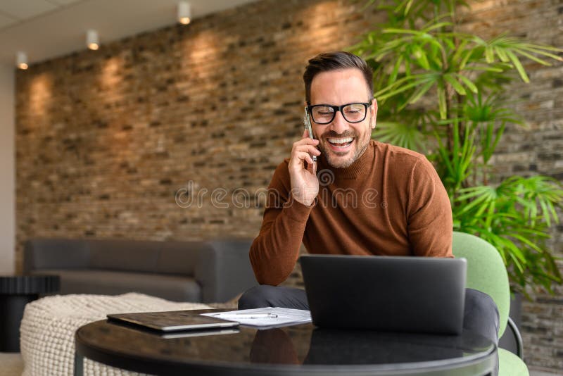 Handsome Manager Discussing Over Phone Call while Working on Project ...