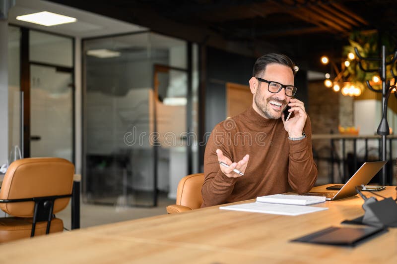 Handsome Manager Discussing Over Phone Call while Working on Project ...