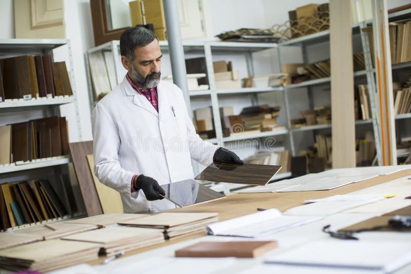 Handsome Mature Engineer in the Laboratory Examines Ceramic Tiles Stock ...