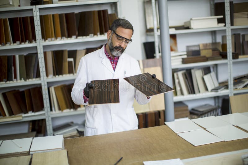 Handsome Mature Engineer in the Laboratory Examines Ceramic Tiles Stock ...