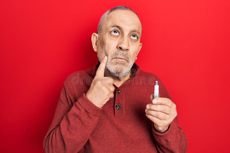 Handsome Mature Man Holding Spark Plug Serious Face Thinking about ...