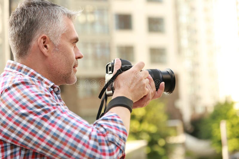 Handsome Mature Man Taking Photo with Professional Camera Stock Photo ...