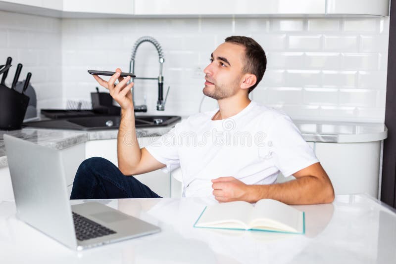 Handsome Mature Man Talking on Mobile Phone while Sitting with Laptop ...