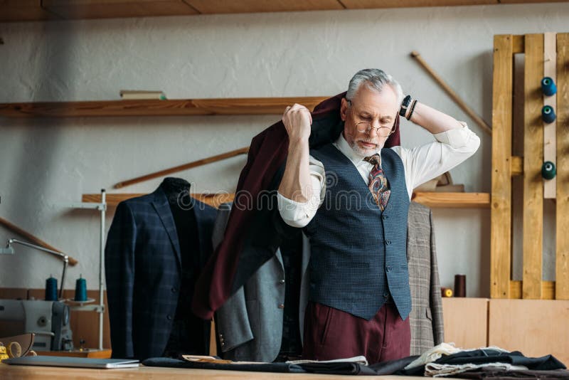Handsome Mature Tailor Putting Jacket on Shoulders Stock Image - Image ...