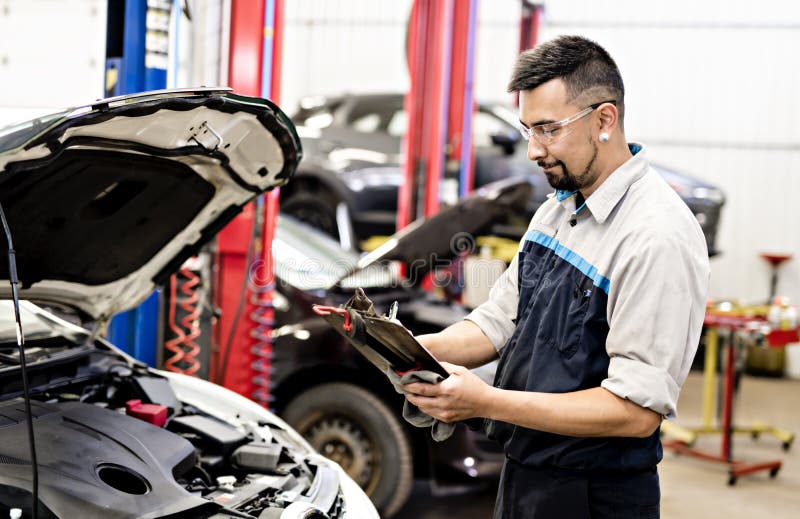 Handsome Mechanic Job in Uniform Working on Car Stock Image - Image of ...