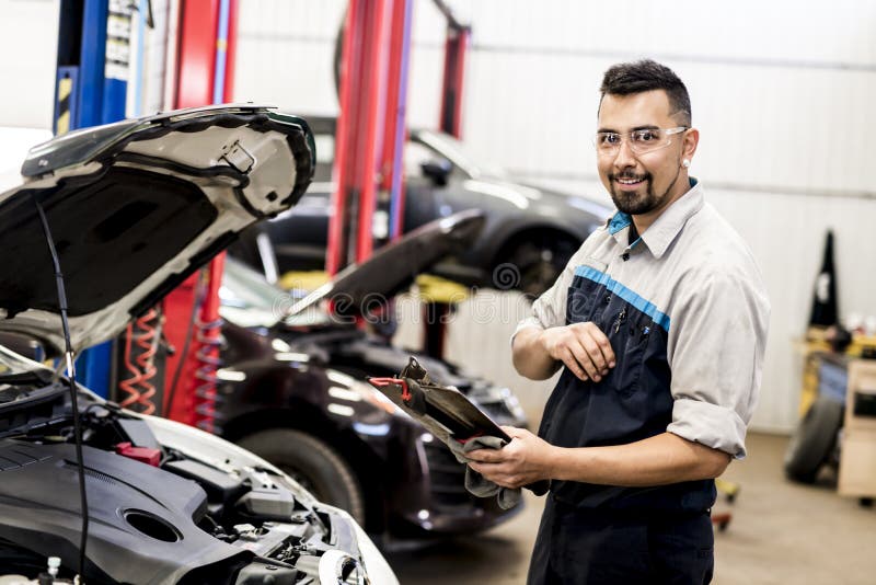Handsome Mechanic Job in Uniform Working on Car Stock Image - Image of ...