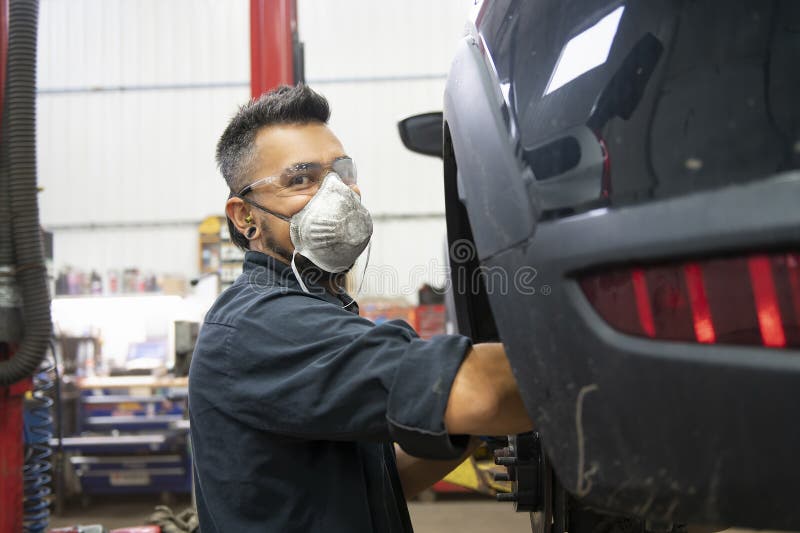 Handsome Mechanic Job in Uniform Working on Car Stock Image - Image of ...