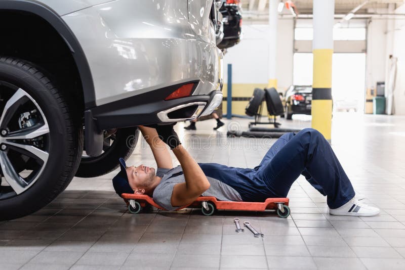 Handsome Mechanic in Uniform and Cap Stock Photo - Image of workshop ...