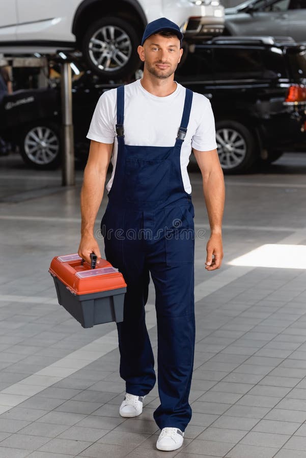 Handsome Mechanic in Uniform and Cap Stock Photo - Image of indoors ...