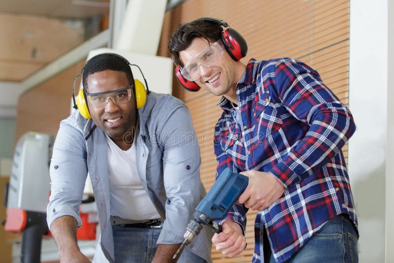 Handsome Men Holding Electric Drill and Smiling at Camera Stock Image ...