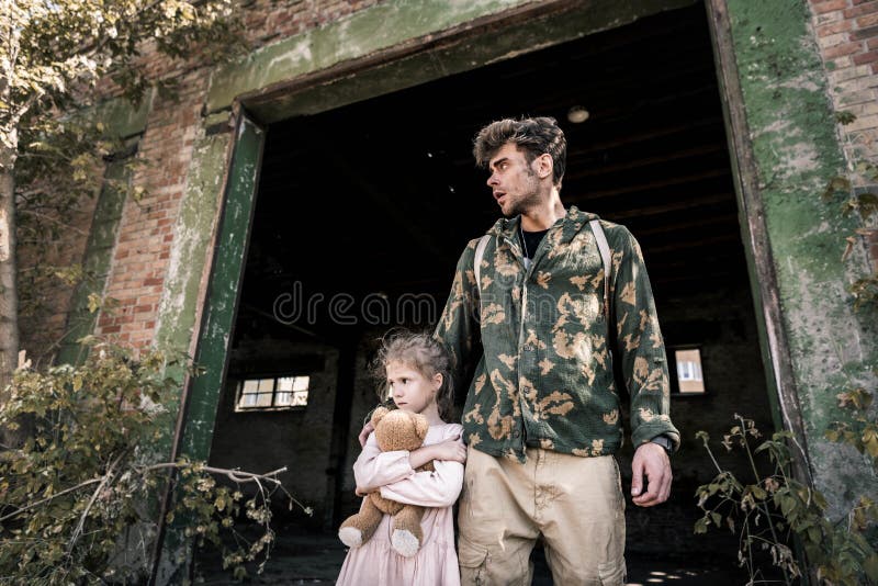 Man Standing with Kid Outside, Post Apocalyptic Concept Stock Photo ...