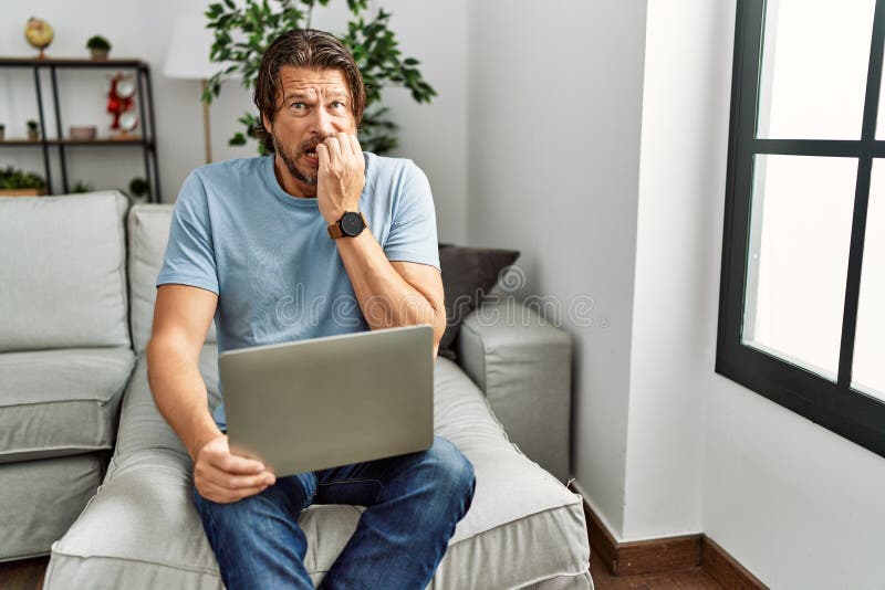 Handsome Middle Age Man Using Computer Laptop on the Sofa Looking ...