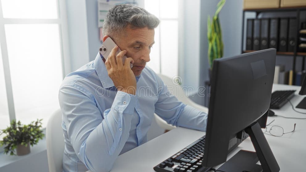Handsome Middle-aged Man Working on Computer while Talking on ...