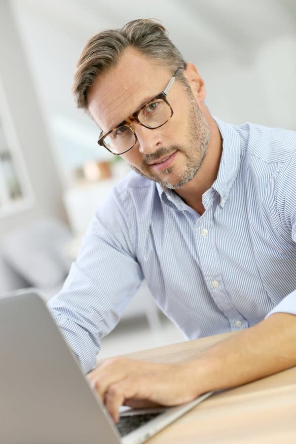 Handsome Middle-aged Man Working on Laptop Stock Photo - Image of ...