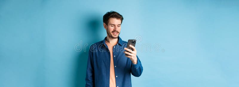 Handsome Modern Guy Using Mobile Phone, Reading Smartphone Screen and ...