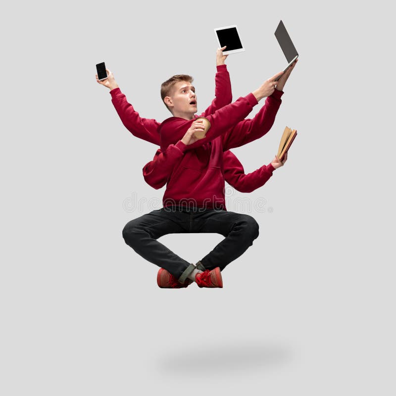 Handsome Multi-armed Student Levitating on Grey Studio Background with ...