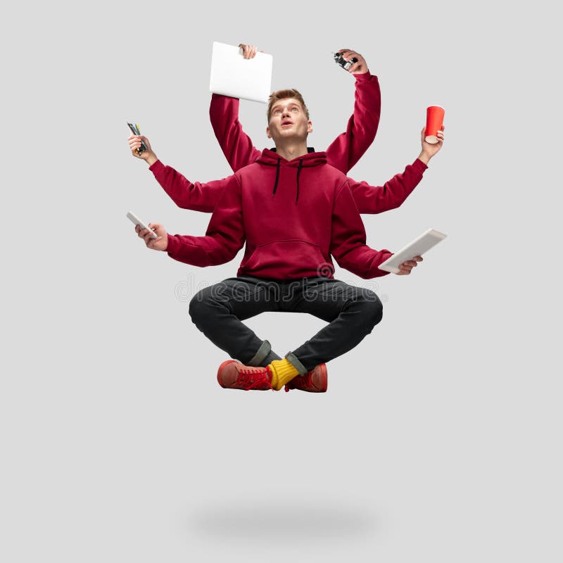 Handsome Multi-armed Student Levitating on Grey Studio Background with ...