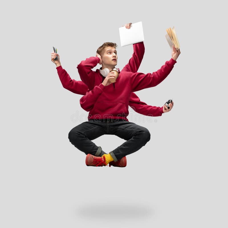 Handsome Multi-armed Student Levitating on Grey Studio Background with ...