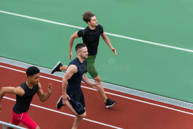 Handsome Multiethnic Athlete Group Run on Running Track Stock Photo ...