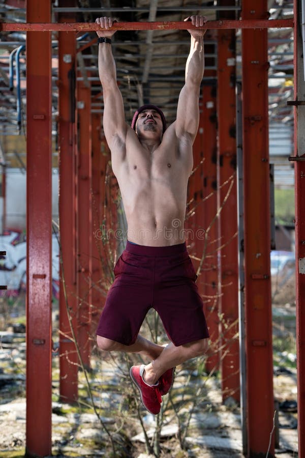 Male Athlete Doing Pull Ups in Warehouse Stock Photo - Image of ...
