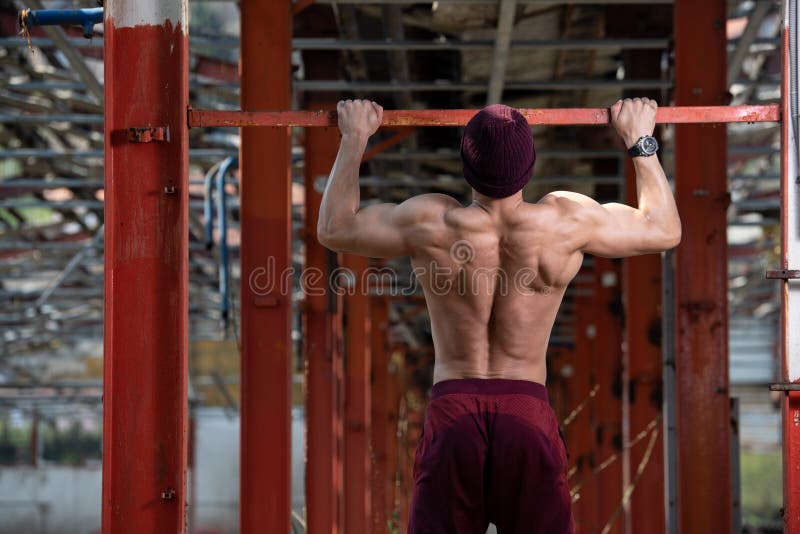 Male Athlete Doing Pull Ups in Warehouse Stock Image - Image of ...