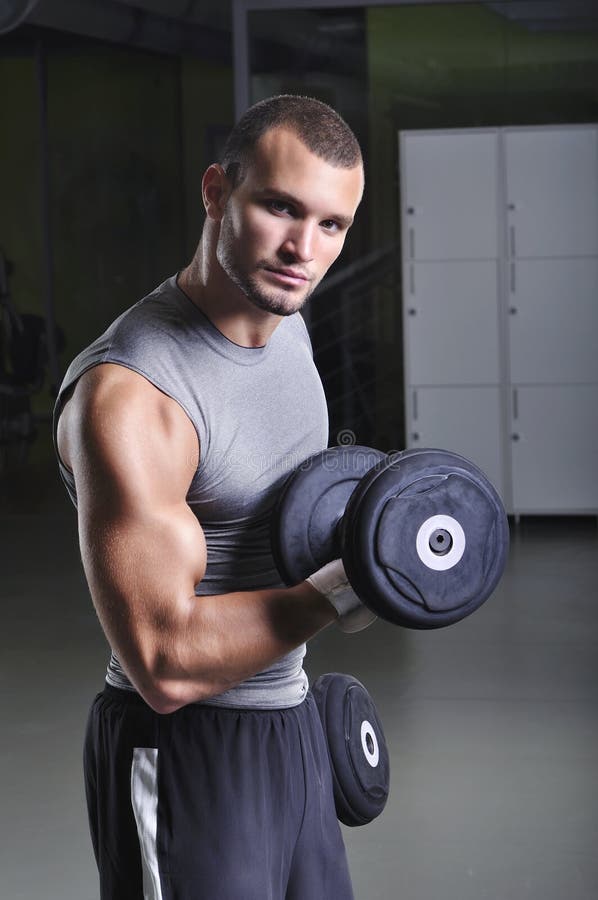 Handsome Muscular Male Model Doing Biceps Exercise Stock Photo - Image ...