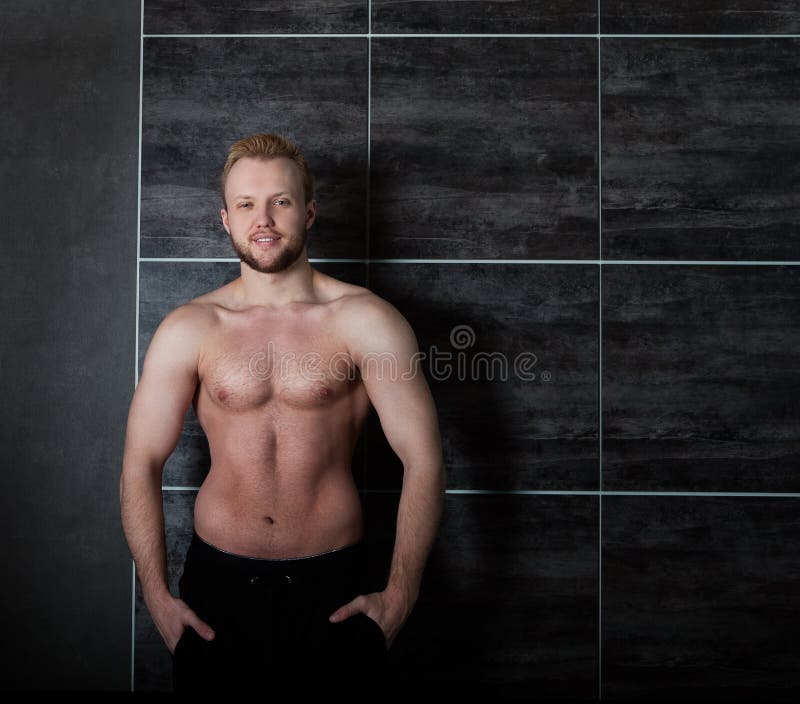 Handsome Muscular Male Model Near the Wall Stock Photo - Image of dark ...