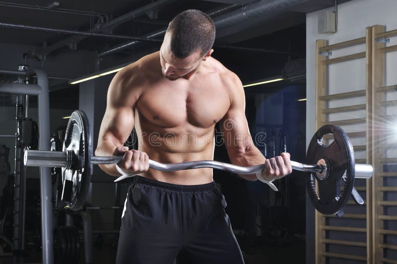 Handsome Muscular Male Model in a Standing Position Doing Biceps Stock ...