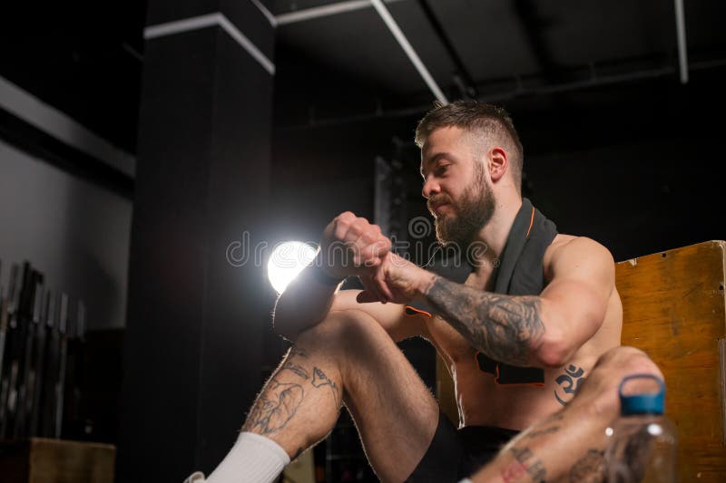 Handsome Muscular Man Checking His Performance on Smartwatch, Resting ...