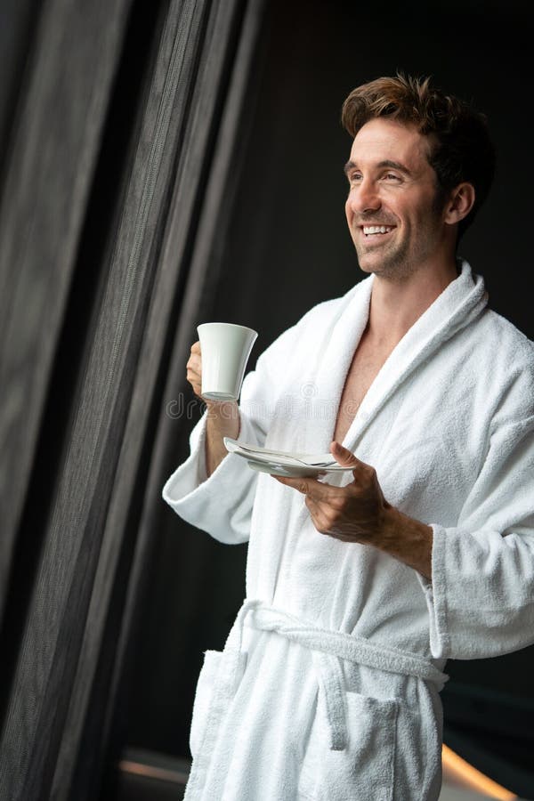 Handsome, Muscular, Young Man Drinking His Morning Coffee in a Hotel ... Handsome, Muscular, Young Man Drinking His Morning Coffee in a Hotel ...