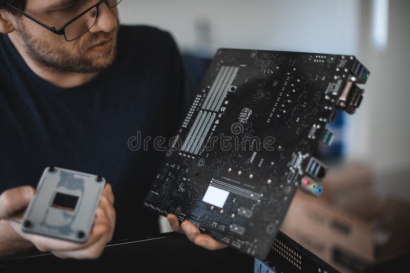 Handsome Nerd Man is Servicing Computer Motherboard and Cooler. Stock ...