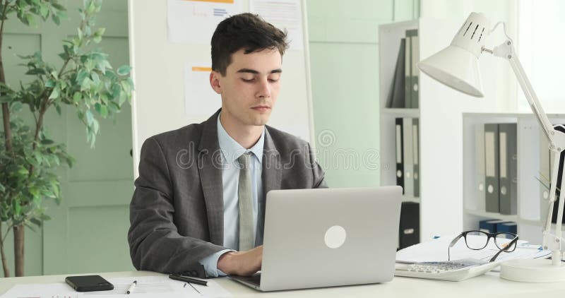 Handsome Office Worker Using Laptop in the Office Stock Video - Video ...
