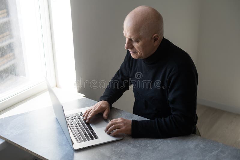 Handsome Old Man Dressed in Smart Casual Style is Using a Laptop ...