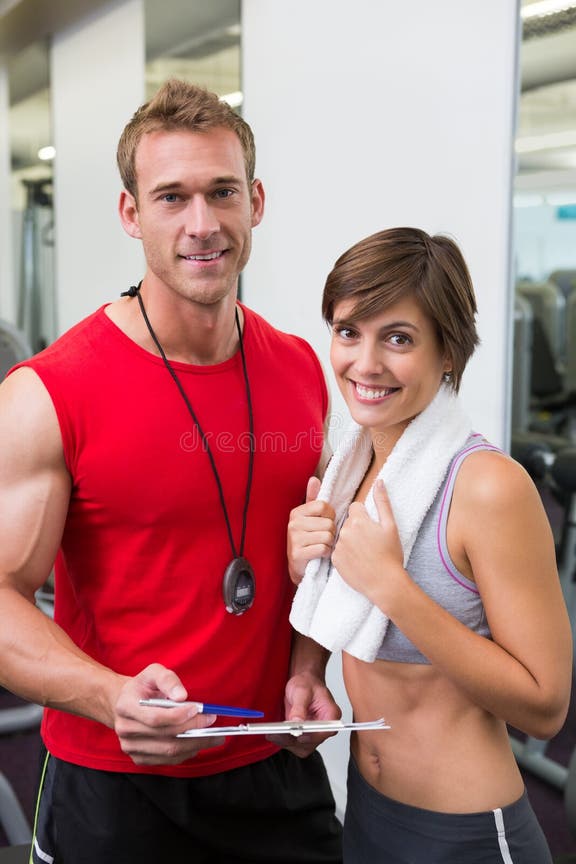 Handsome Personal Trainer with His Client Smiling at Camera Stock Image ...
