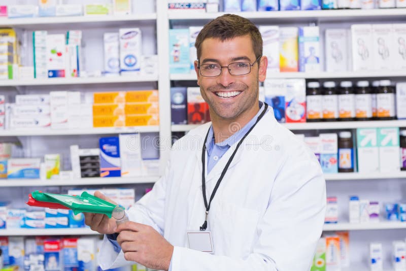 Handsome Pharmacist Holding Medicine Stock Image - Image of ...