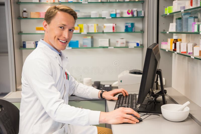 Handsome Pharmacist Using the Computer Stock Image - Image of treatment ...