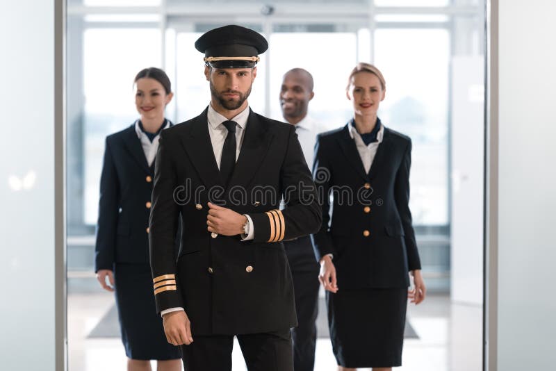 Handsome Pilot at Airport with His Team Looking Stock Photo - Image of ...