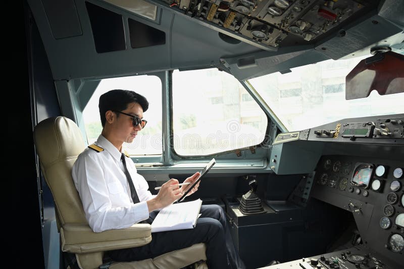 Handsome Pilot Wearing Sunglasses Using Digital Tablet, Preparing for ...